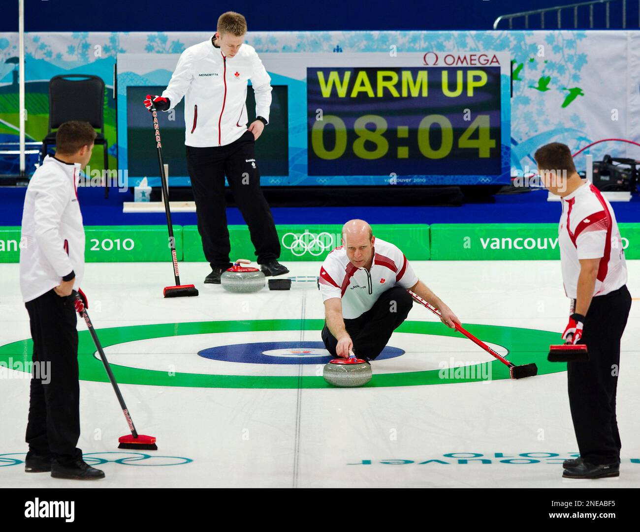 Team Canada skip Kevin Martin, center, throws a rock as third John ...