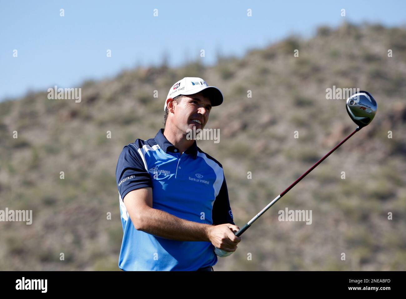Padraig Harrington, of Ireland, watches after his tee shot during ...