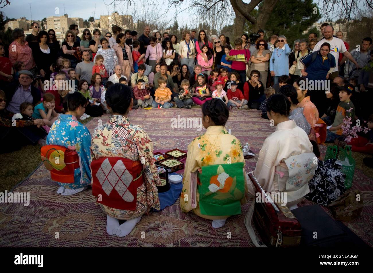 Japanese women perform a traditional ritual for the cherry blossom ...