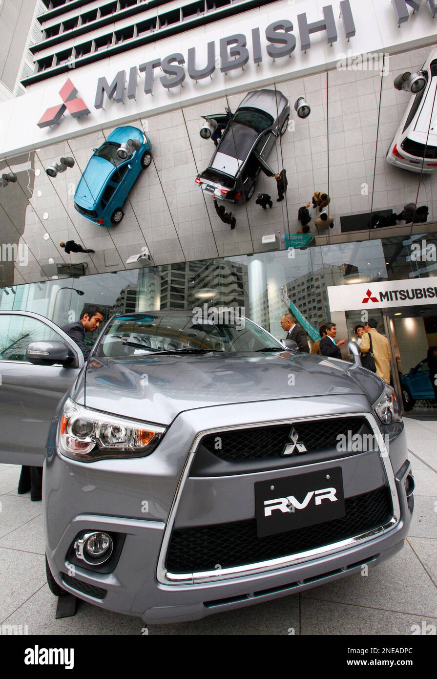 A visitor examines Mitsubishi Motors Corp.'s new compact crossover RVR ...