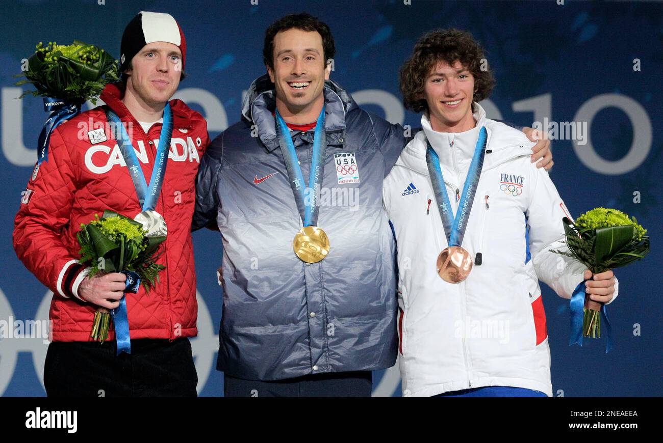USA's gold medalist Seth Wescott is flanked by Canada's silver medalist ...