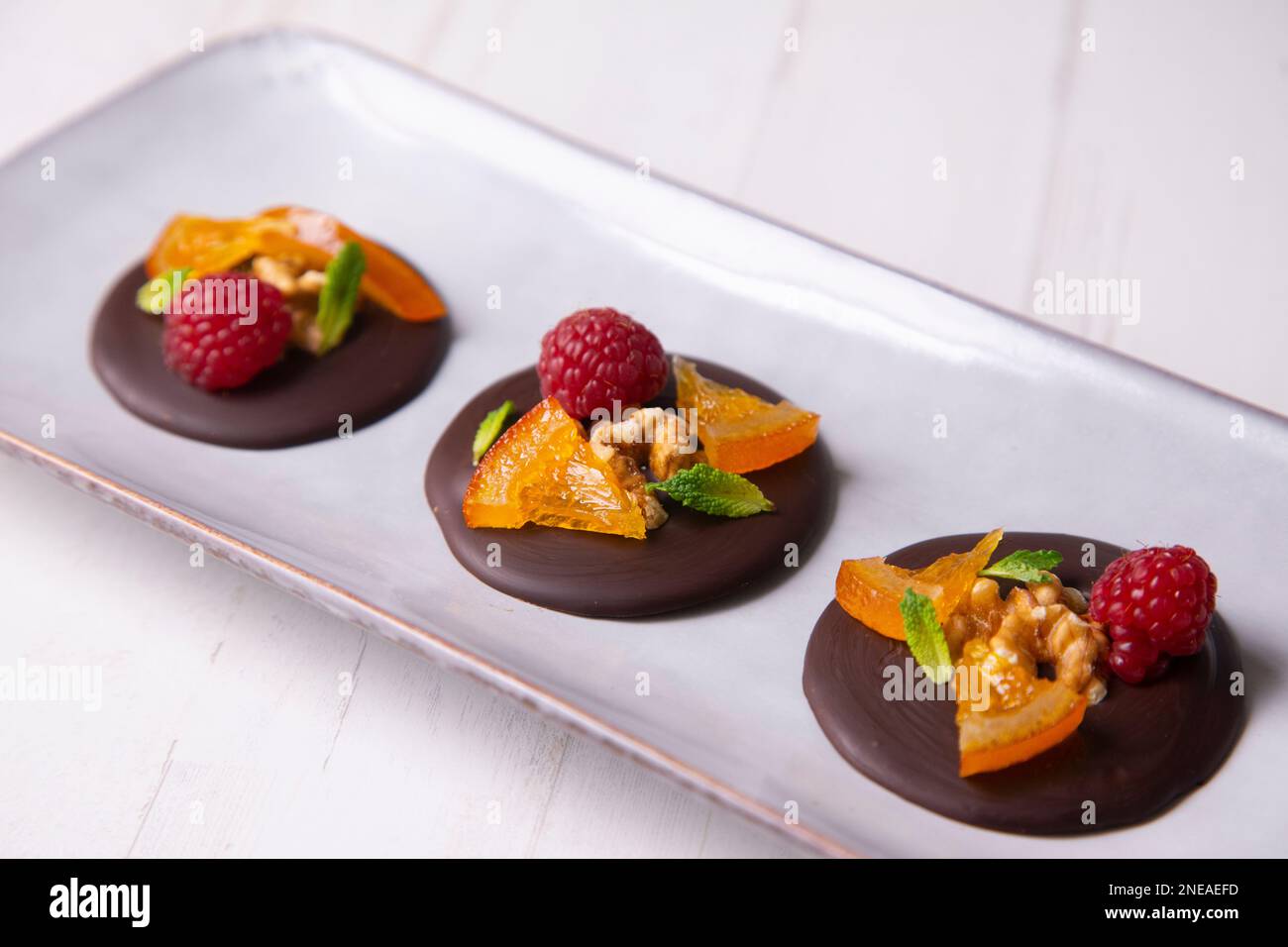 Chocolate dessert with candied orange, raspberry and nuts Stock Photo ...