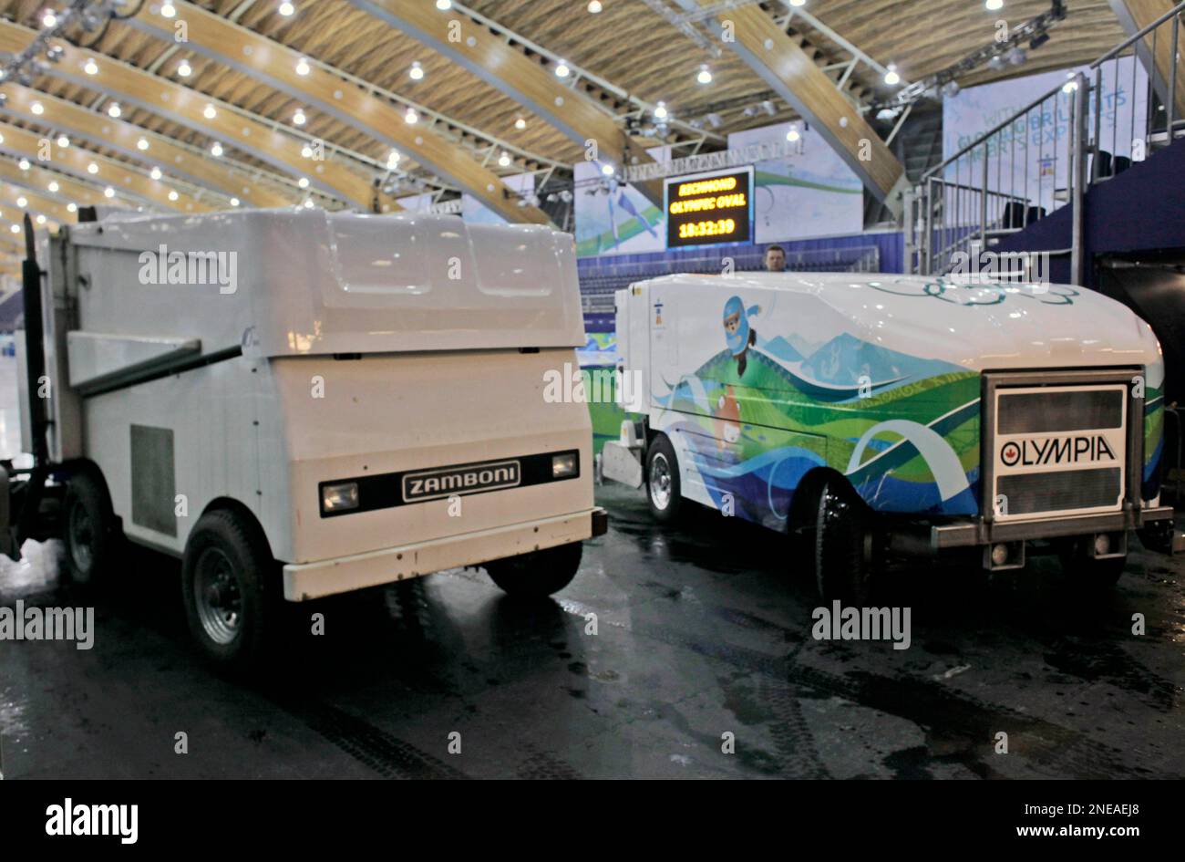 An Olympia ice resurfacing machine passes a Zamboni machine at the ...
