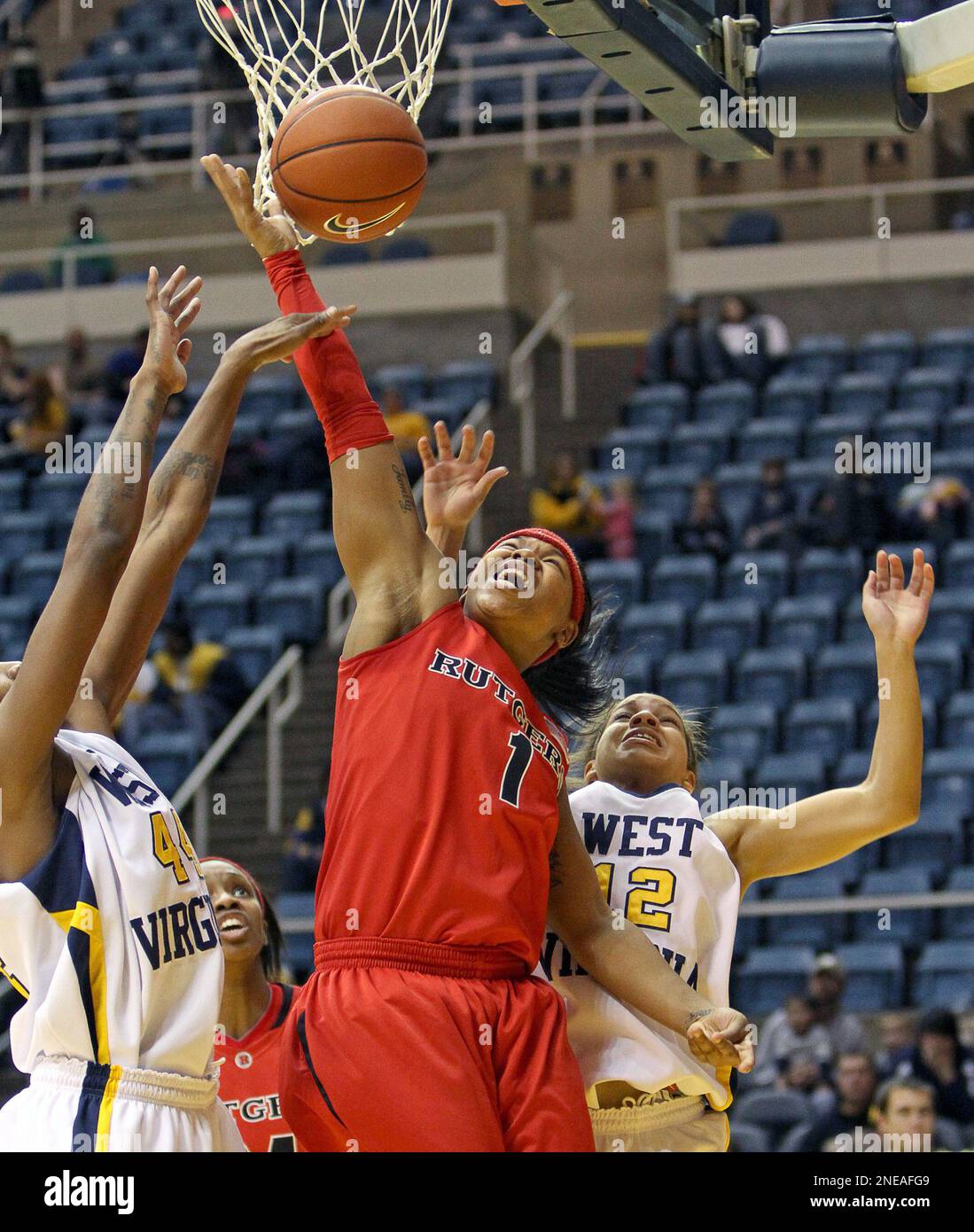 Rutgers' Khadijah Rushdan (1) attempts a layup over West Virginia's ...