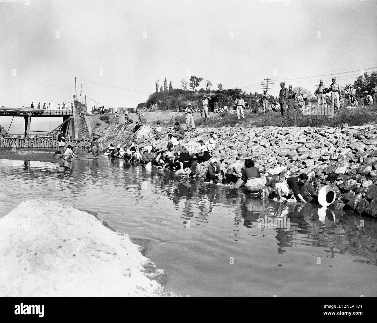 South Korean troops appear amused as they line the Songchon River at ...