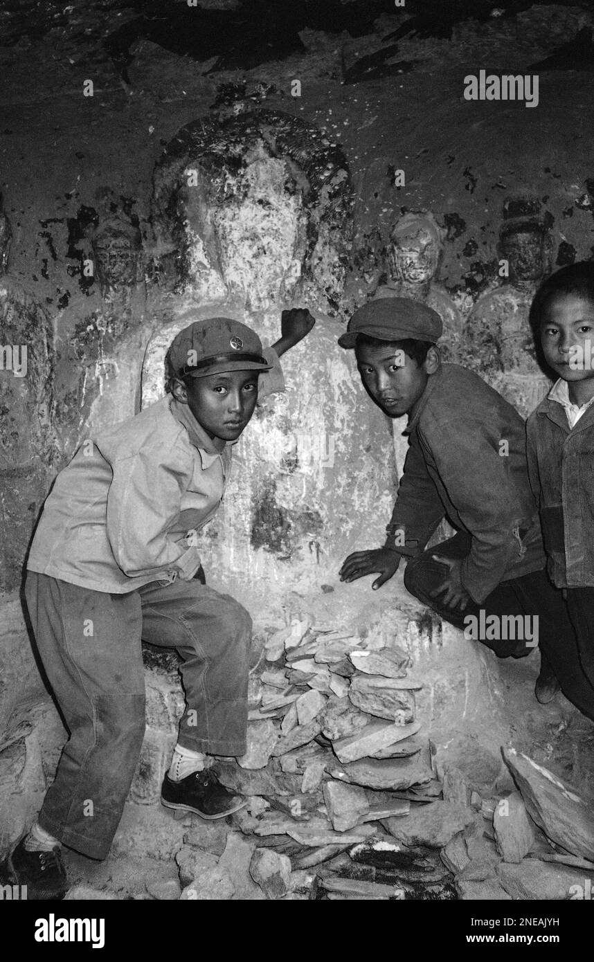 Two boys play in a shrine in Peking, China on July 20, 1979 that was ...