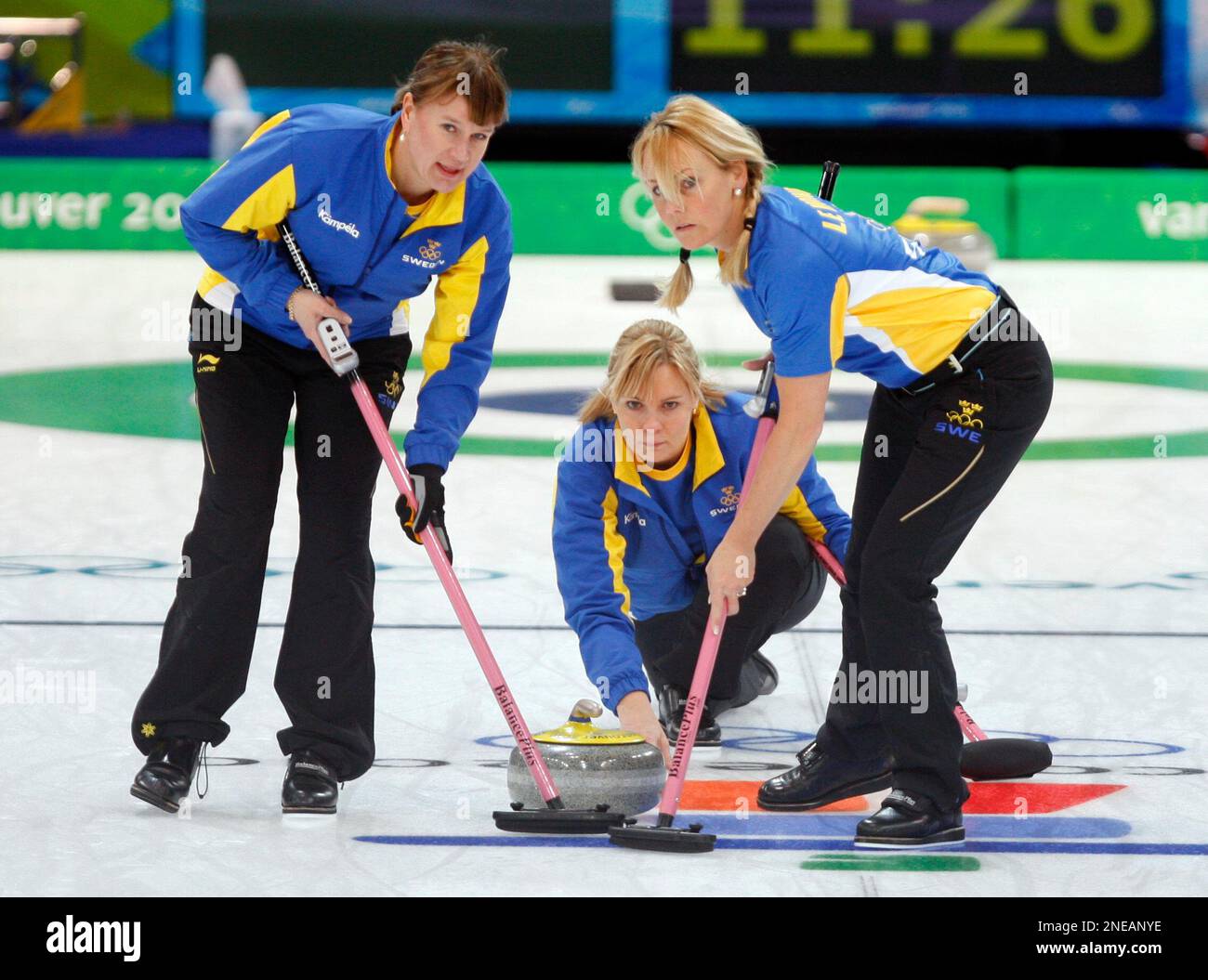 Sweden women curlers Cathrine Lindahl, left, and Anna LeMoine, prepare ...