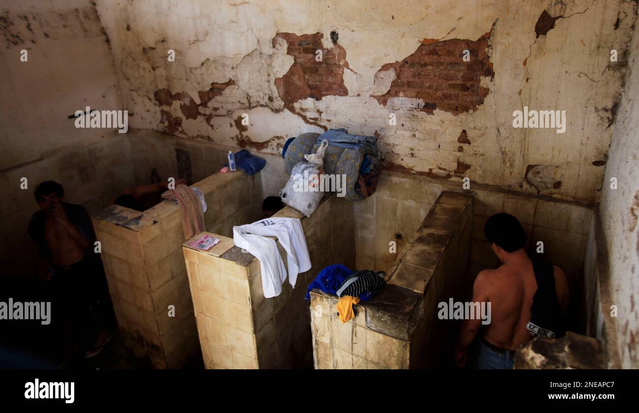 Inmates shower at the Tacumbu prison in Asuncion, Monday, Feb. 15, 2010 ...