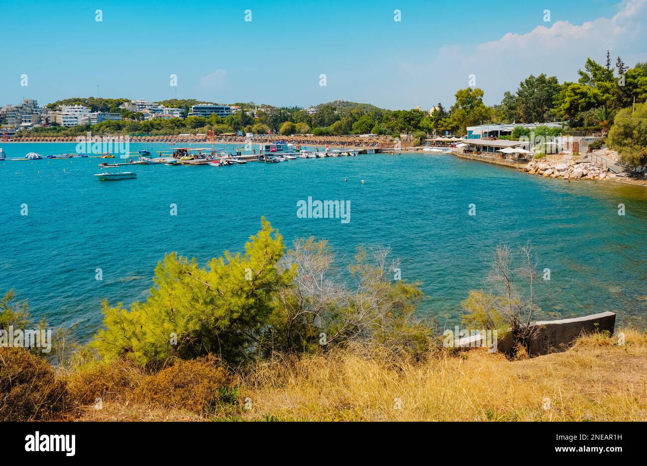 Vouliagmeni, Greece - September 1, 2022: A view of a small pier in Vouliagmeni beach, in Greece ...