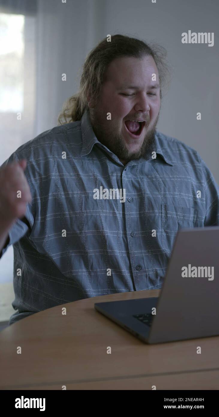 Happy man in front of computer receiving excellent news dancing in ...