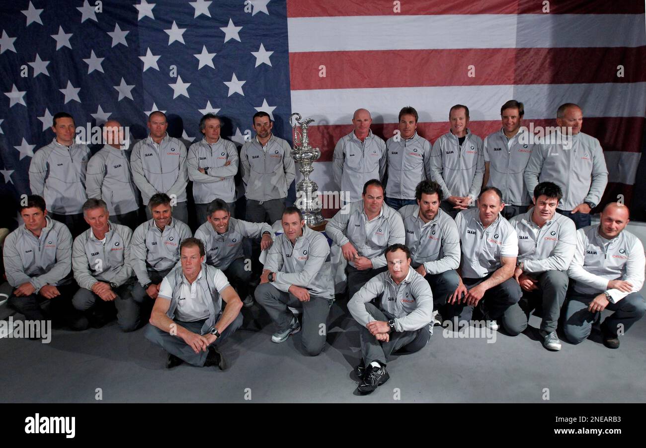 BMW Oracle Racing team members pose with the trophy for the media in ...