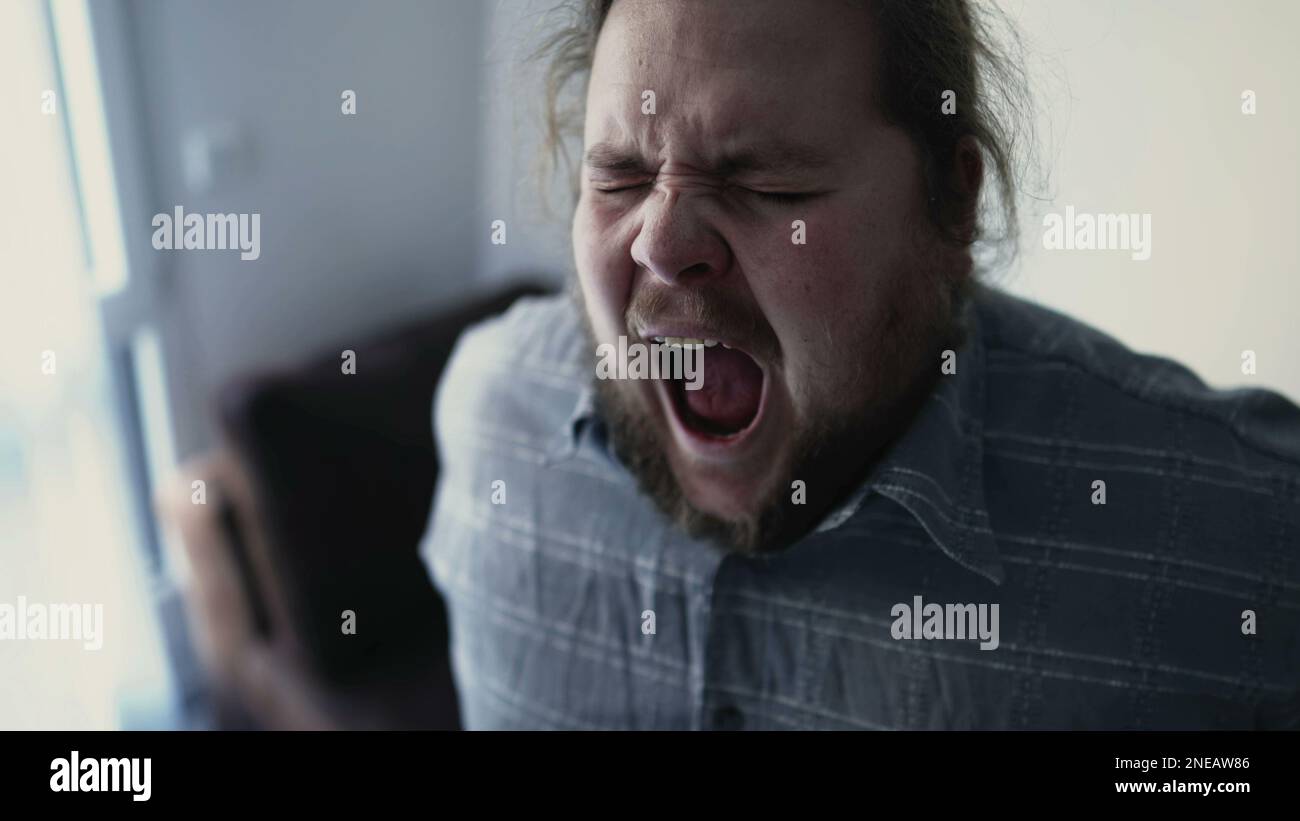 One overweight man suffering from back pain. A sedentary male person ...