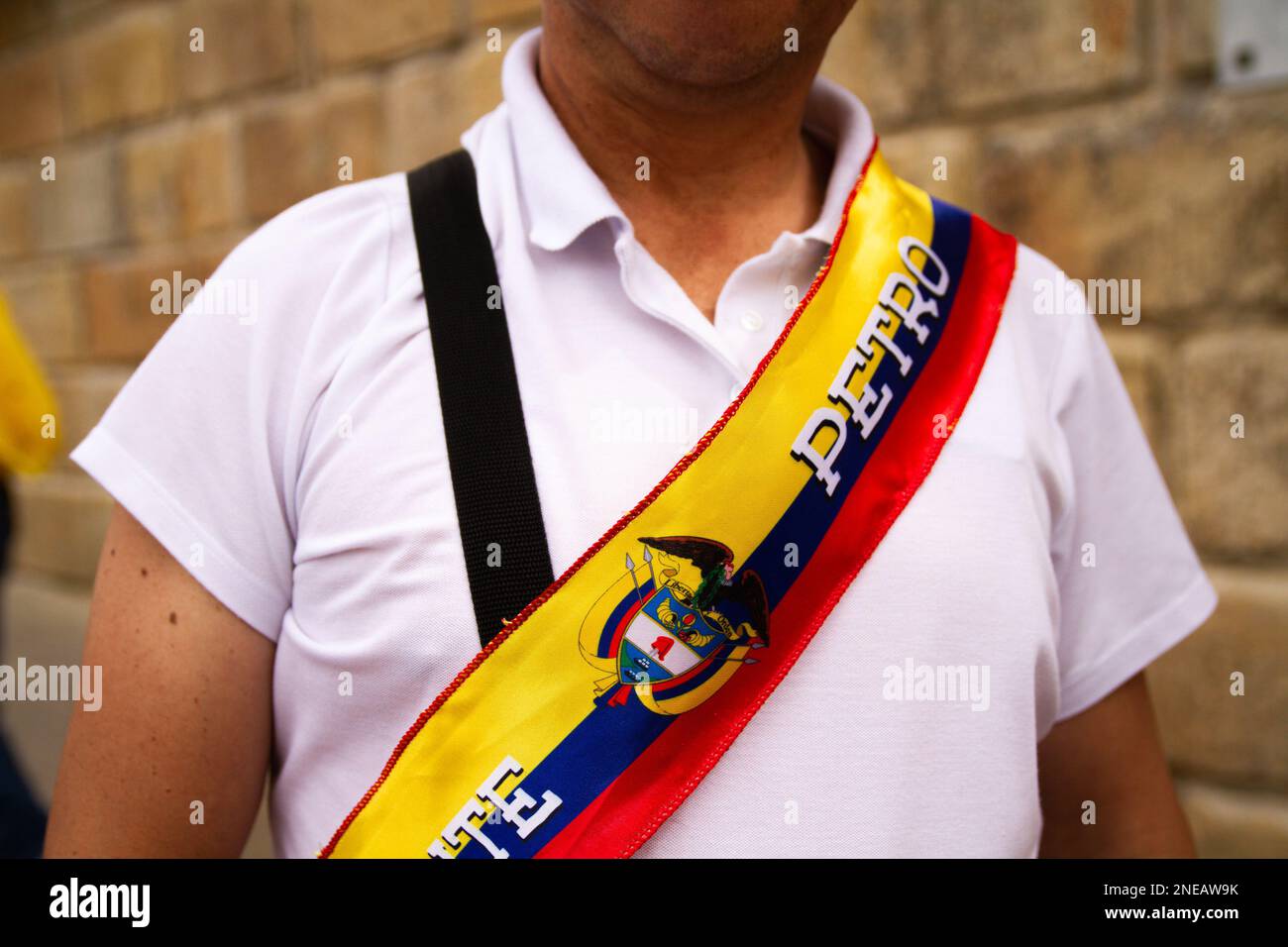 A demonstrator wears a Colombian flag with Colombian president Gustavo ...