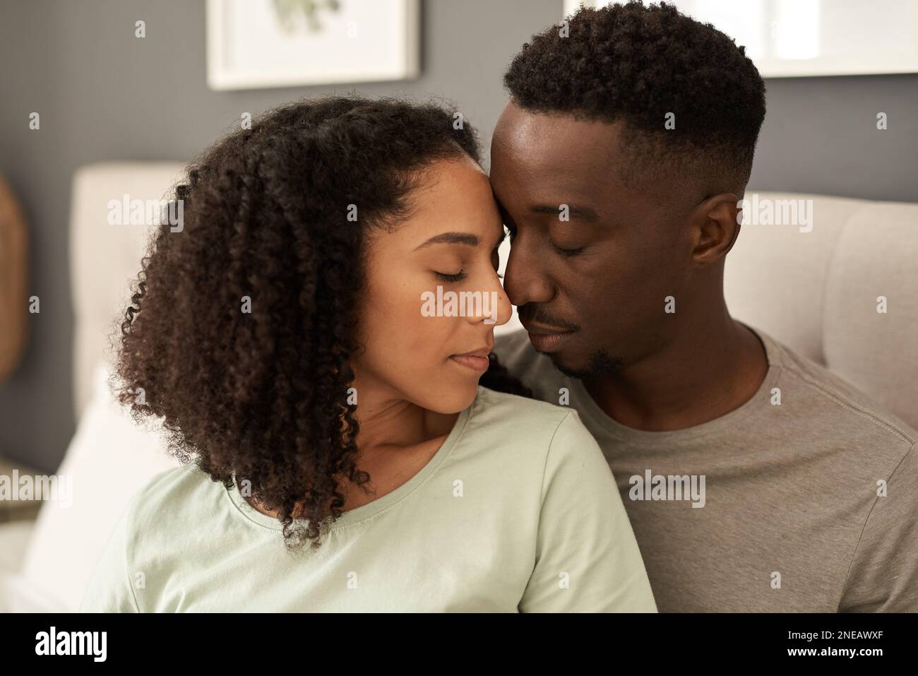 Affectionate young biracial couple sitting hi-res stock photography and ...