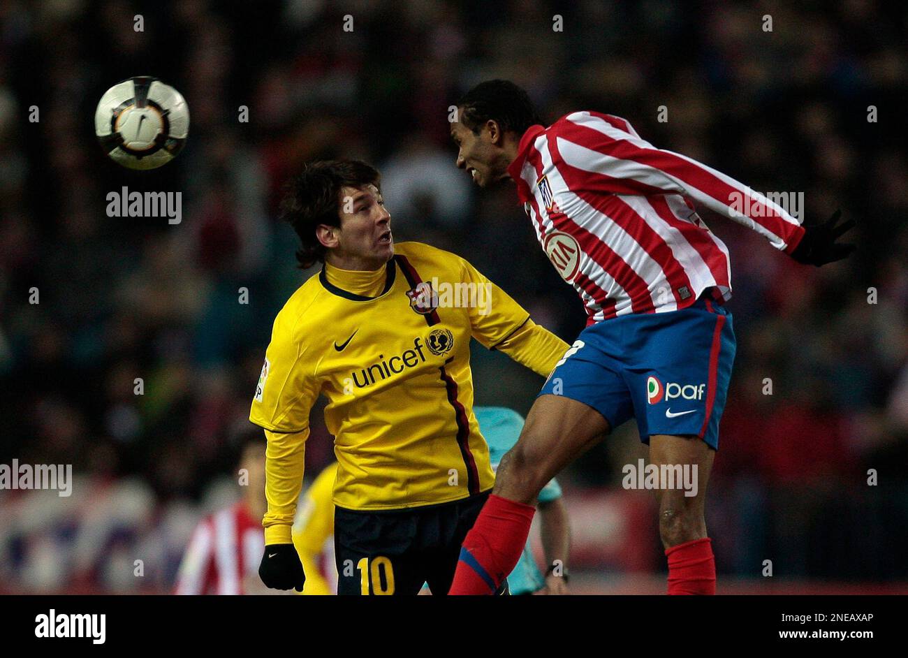 Barcelona's Lionel Messi from Argentina, left, jump for a high ball ...