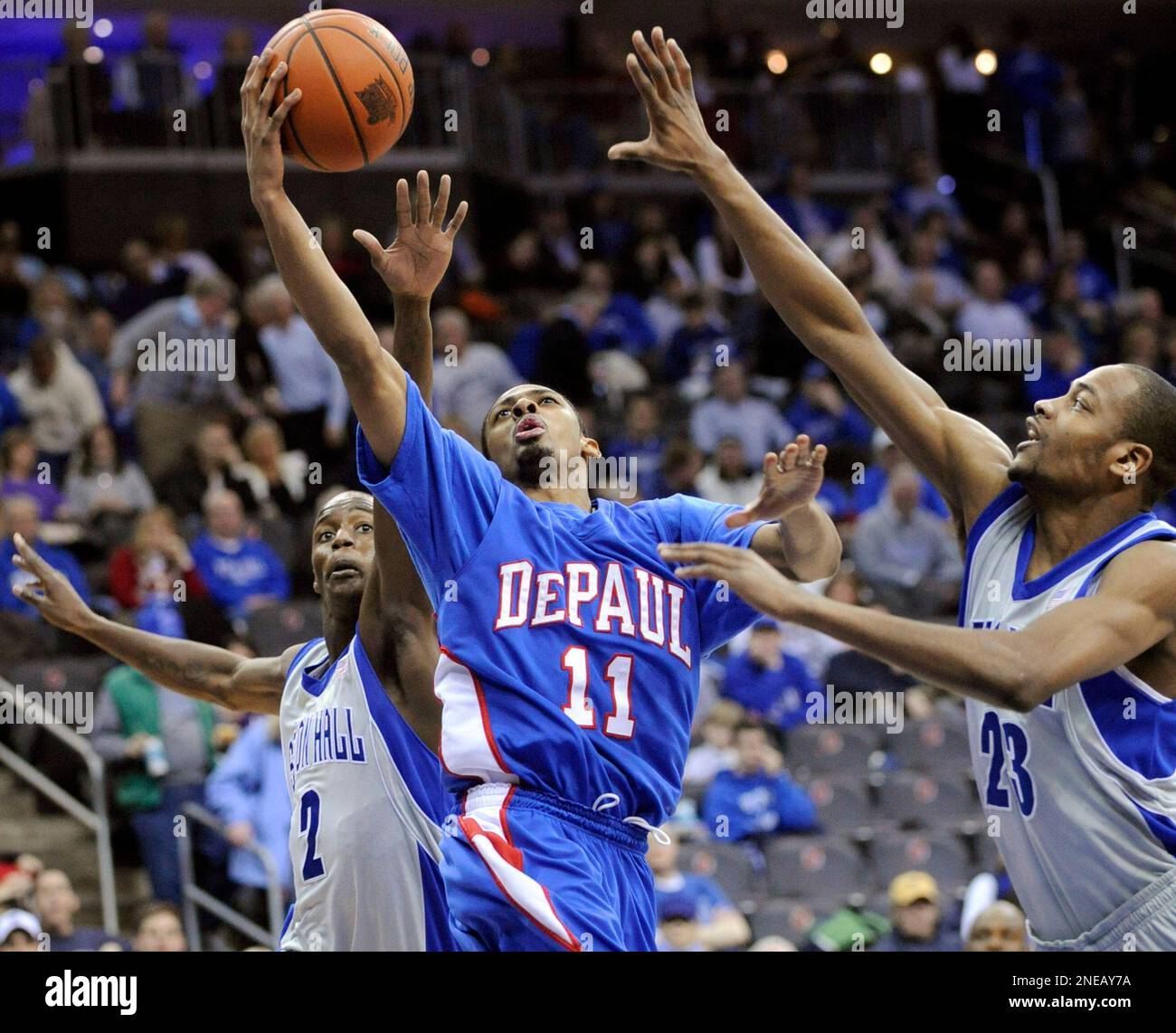 DePaul's Jeremiah Kelly goes up with a shot between Seton Hall's Keon ...