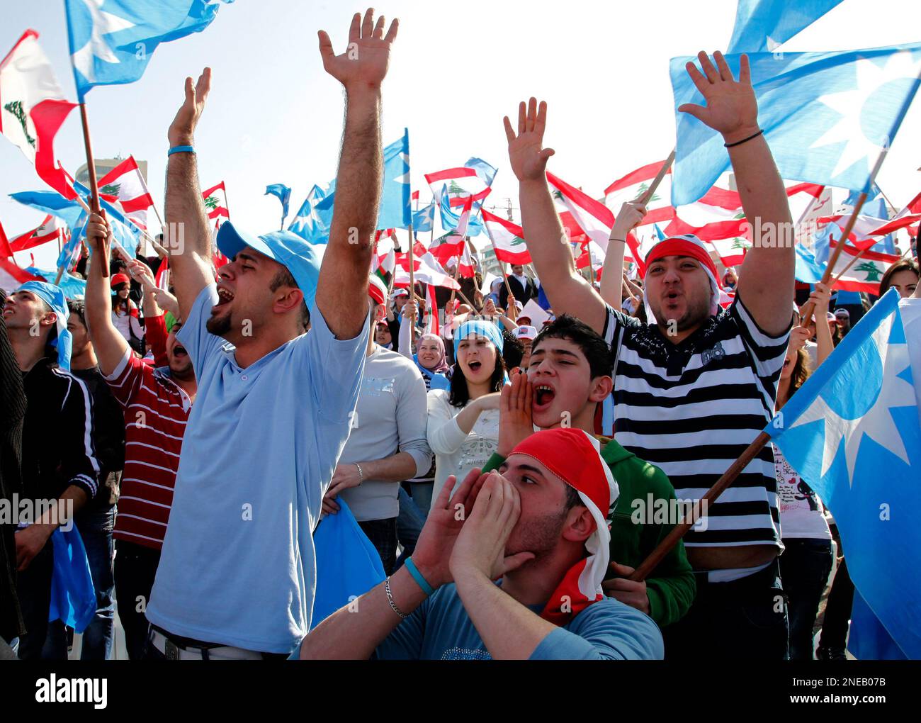 Lebanese men react as they carry national flags and Saad Hariri's ...