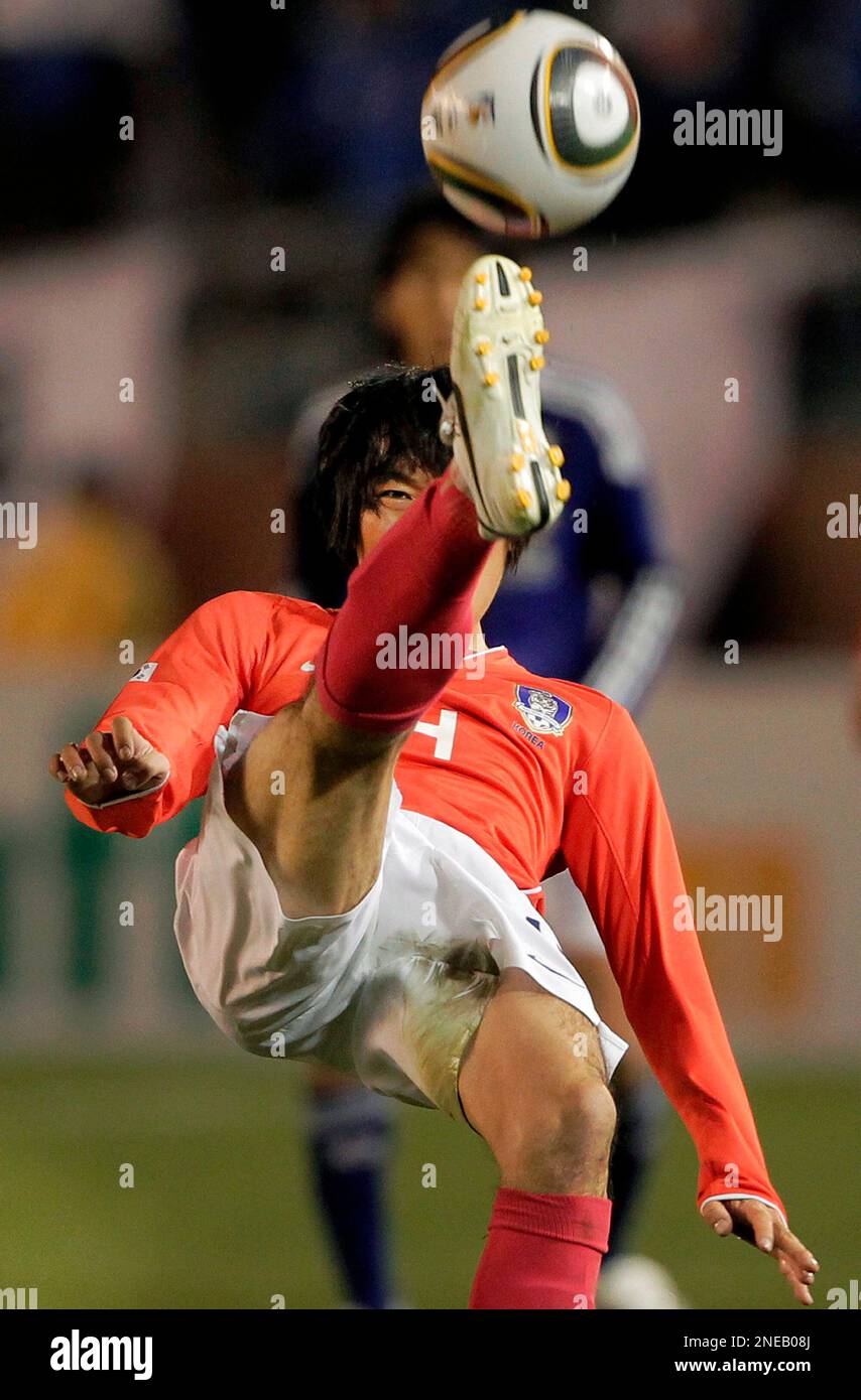 South Korea's defender Cho Yong-hyung kicks the ball over his head ...