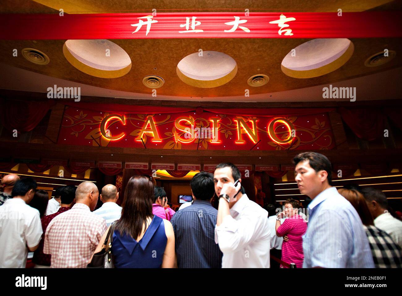 People wait to enter the casino in Singapore, Sunday, Feb. 14, 2010. Resorts World Sentosa ...