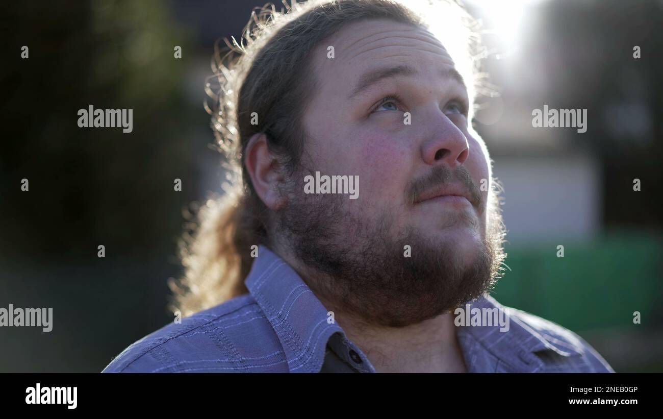 Happy contemplative young man opening eyes to sky with HOPE and FAITH ...