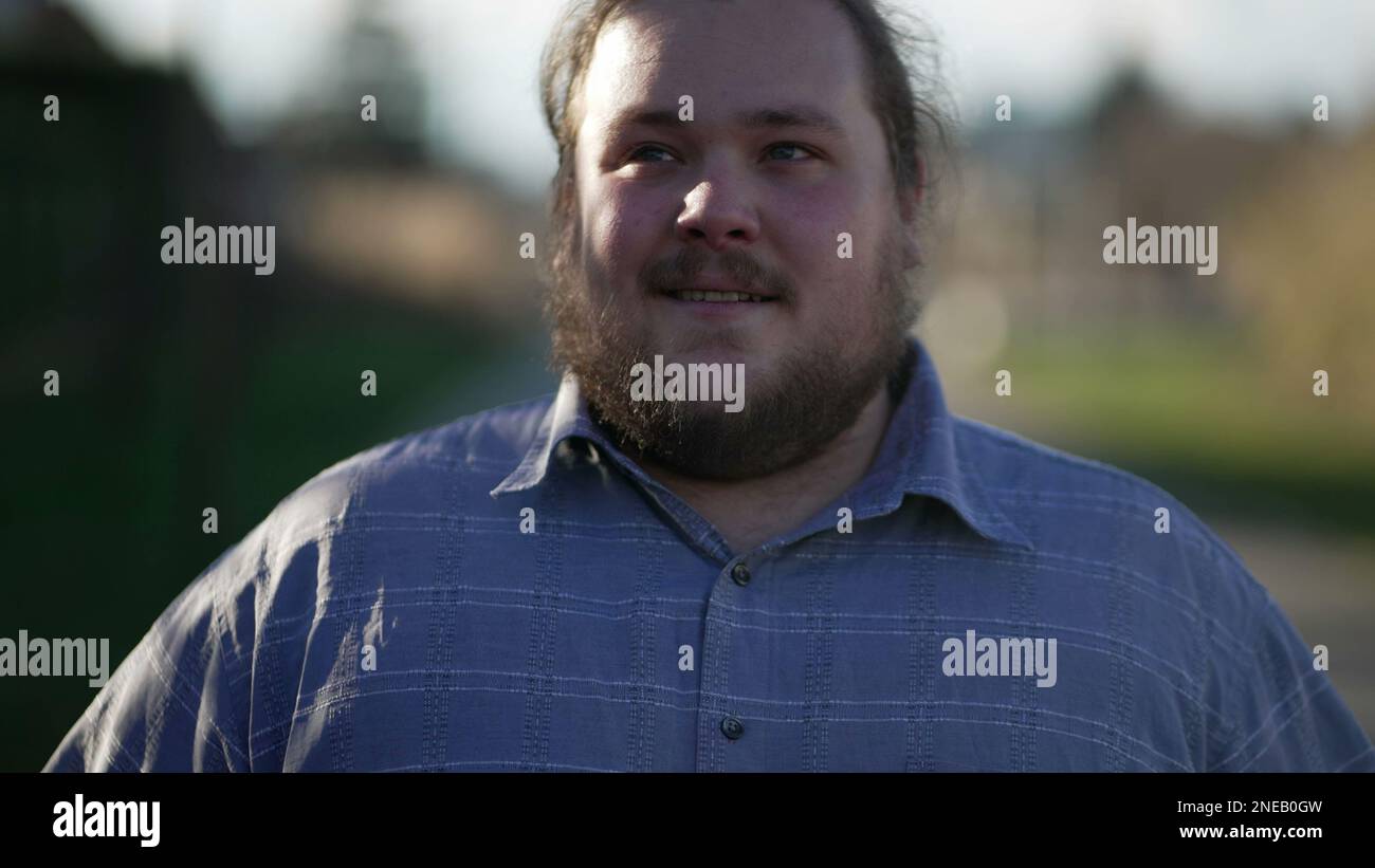 Close up face of a positive young man walking with confidence outside ...