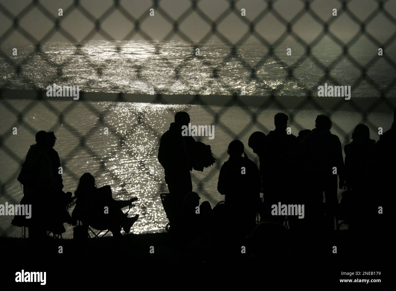 Surfing fans crowd onto the shoreline bluffs to watch the heats at the ...