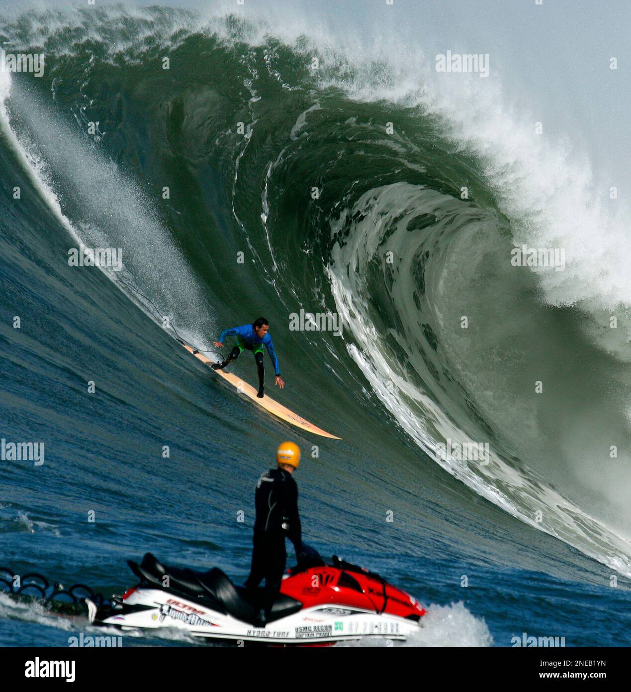 Josh Loya surfs down a giant wave during the Mavericks surf contest ...
