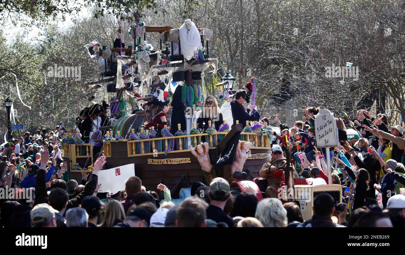 A float depicting a pirate ship winds its way through a large crowd ...
