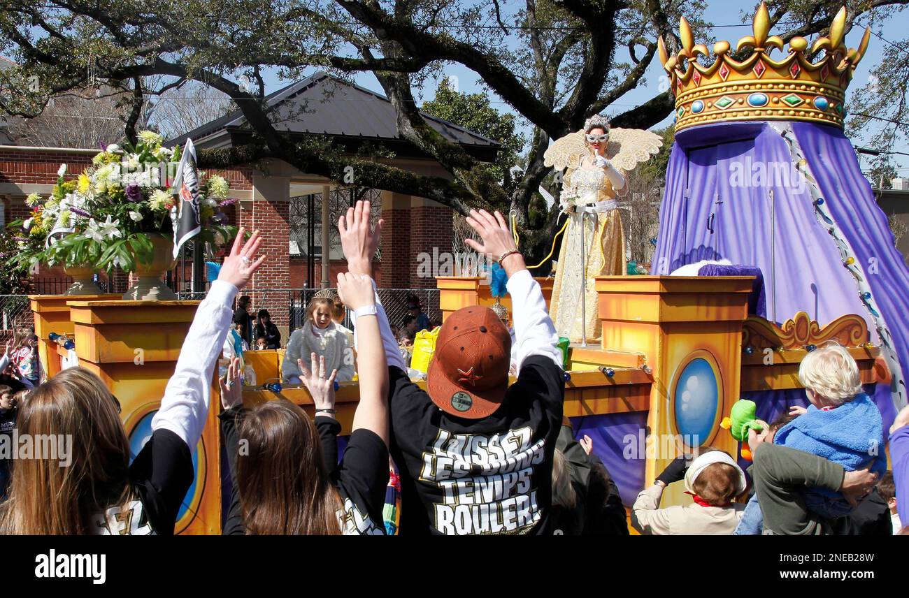The Queen of the Iris parade waves to the crowd during her ride through ...
