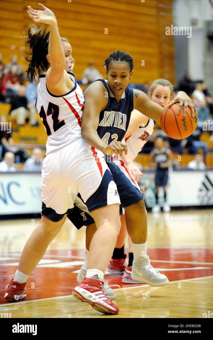 Duquesne guard Rachel Frederick (12) defends as Xavier forward April ...