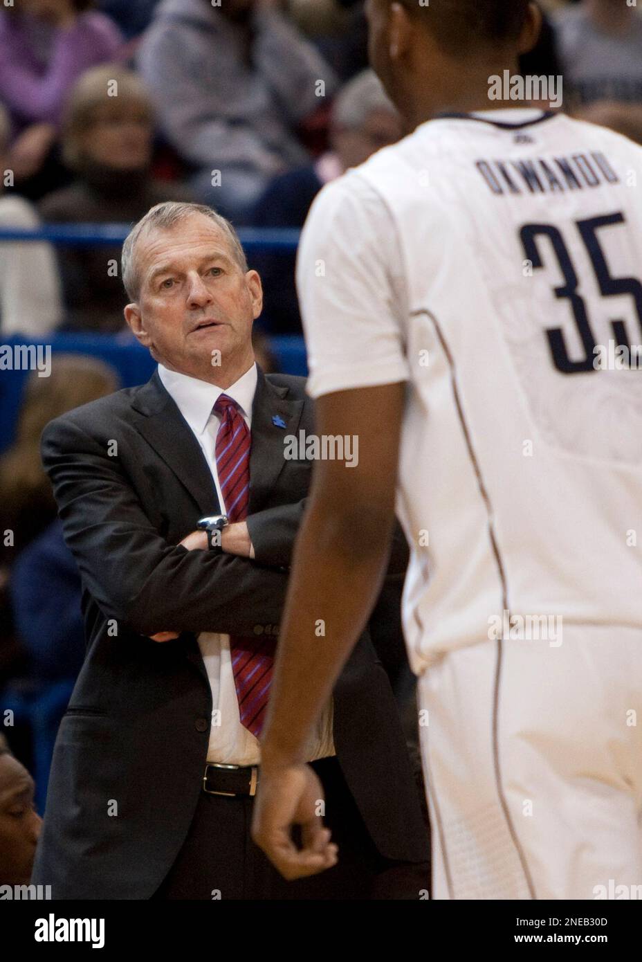 Connecticut head coach Jim Calhoun, left, stares at Charles Okwandu ...
