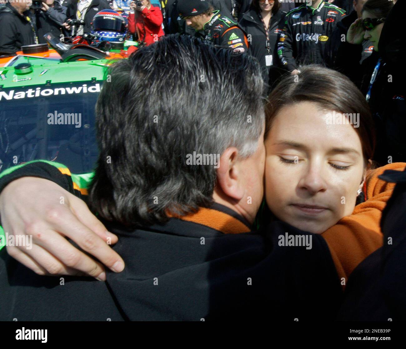 NASCAR driver Danica Patrick, right, gets a hug from her father TJ ...