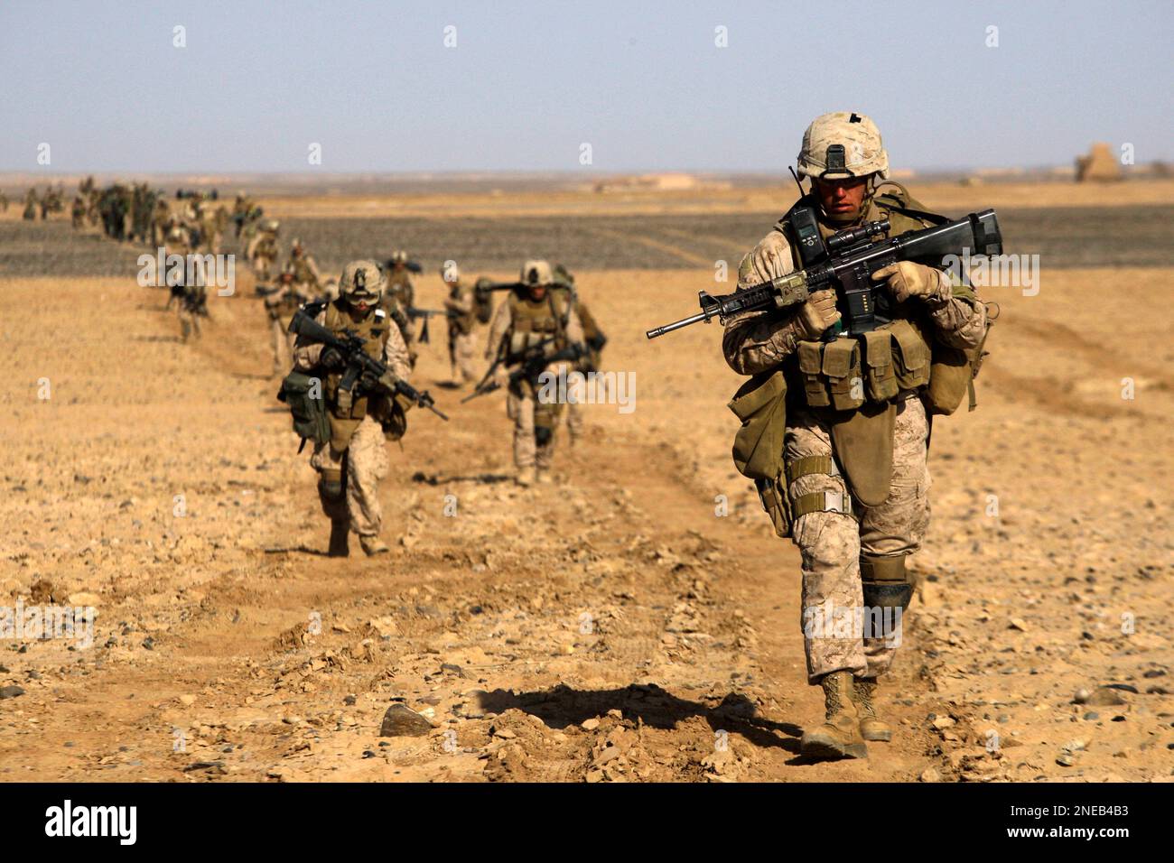 U.S. Marines from 3rd Battalion, 6th Marine Regiment walk in a column ...
