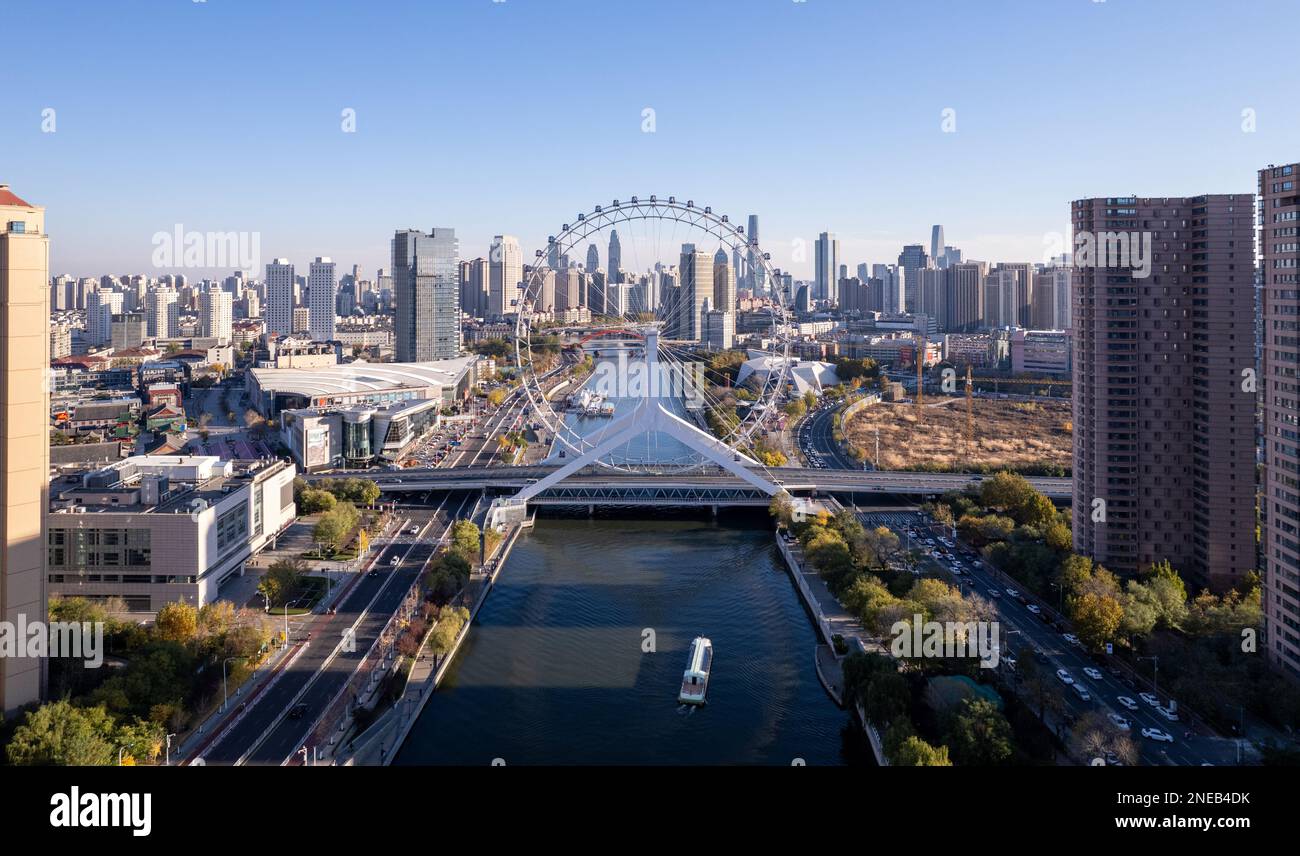 An aerial shot of the Tianjin Eye over the lake amid the skyscrapers ...