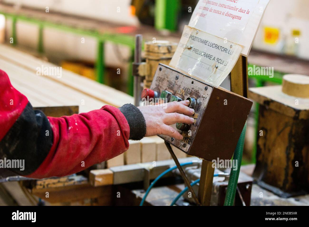 A construction worker pressing a button on an electrical machine Stock ...