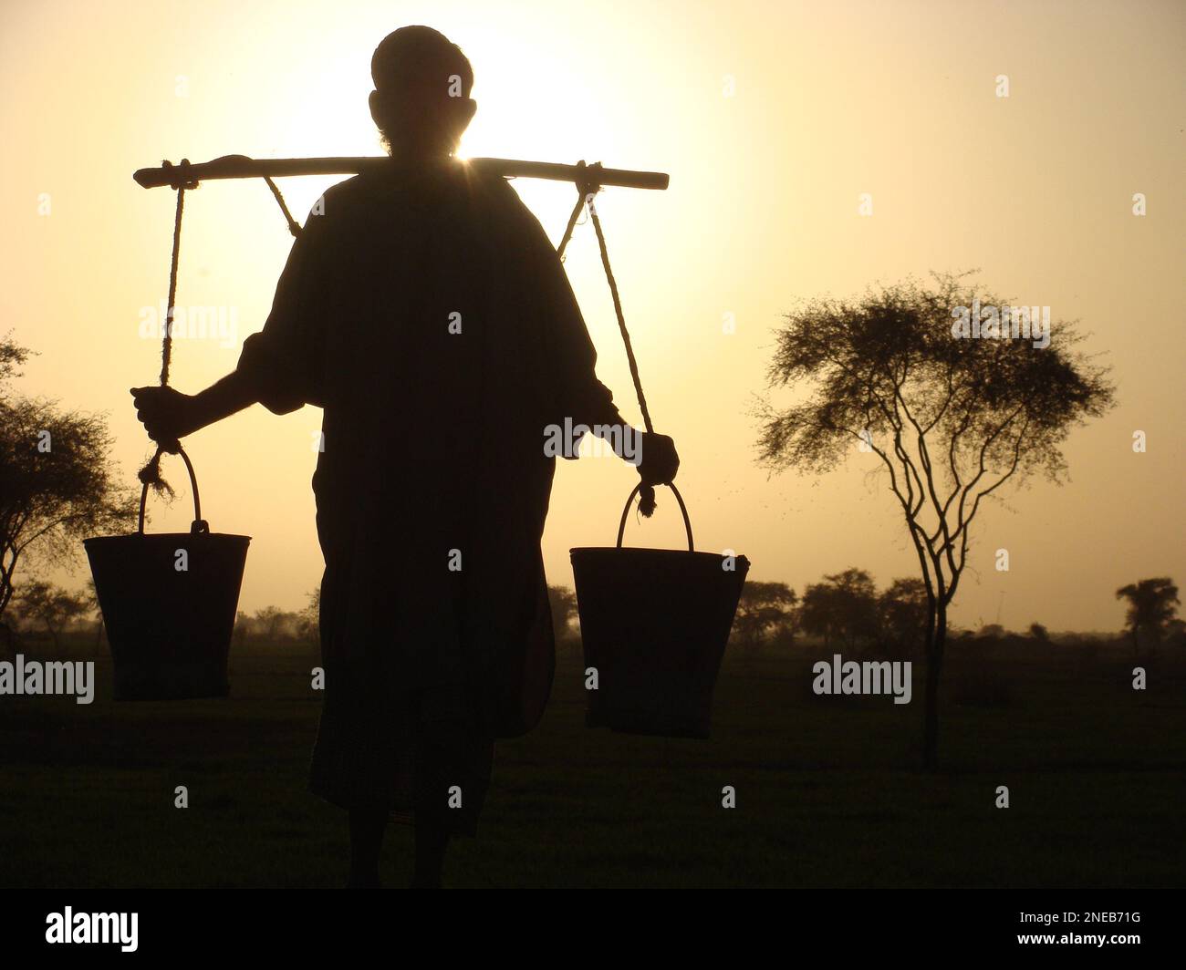 A Pakistani villager fetches water from a distance for his domestic use ...