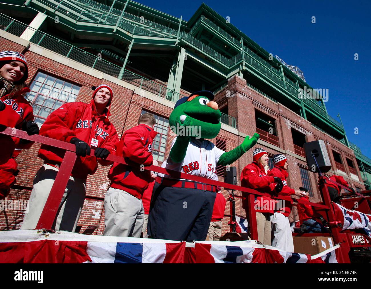Boston Red Sox's mascot "Wally the Green Monster," center, waves to a ...