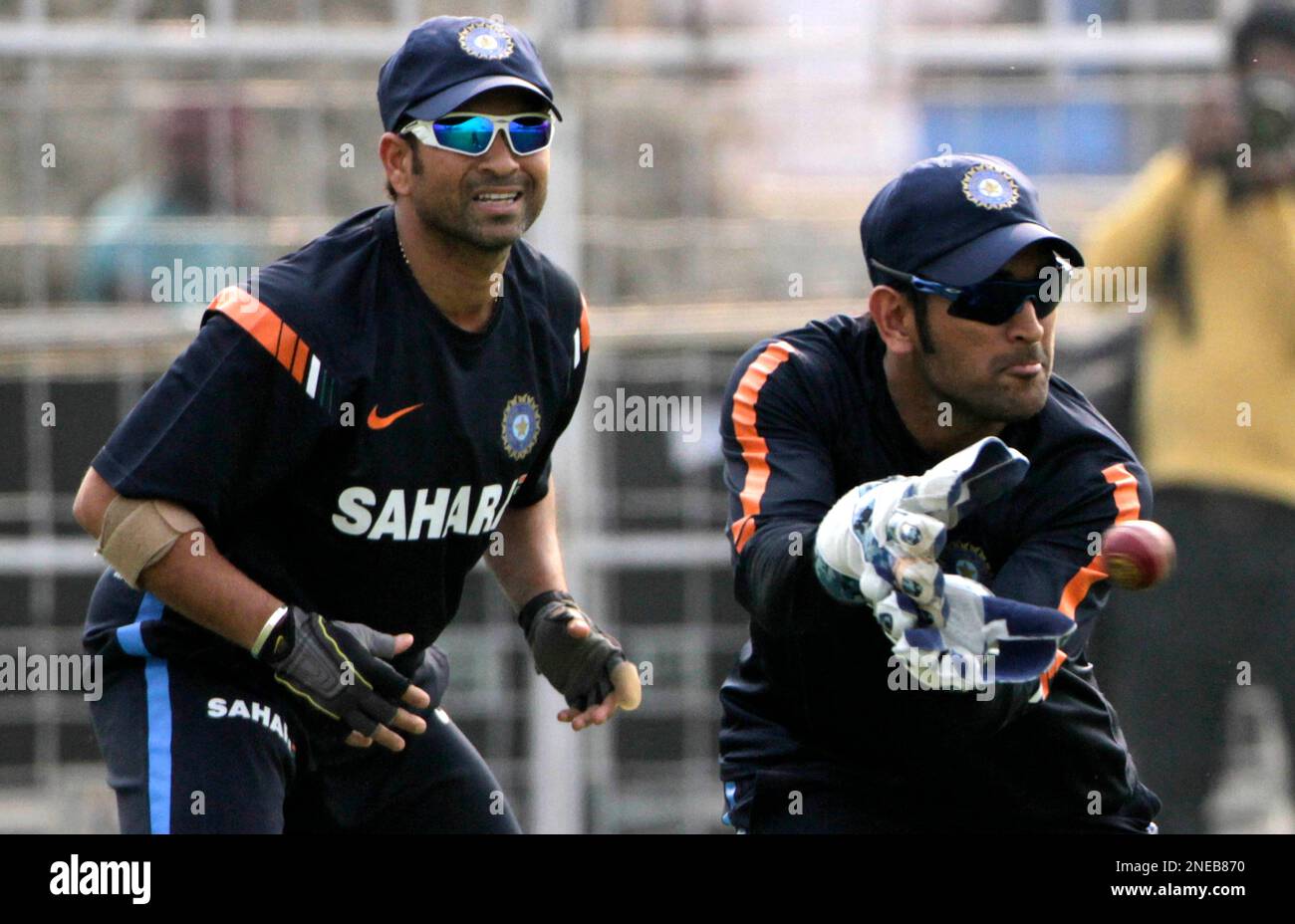 Indian cricketer Mahendra Singh Dhoni, right, takes a catch as Sachin ...