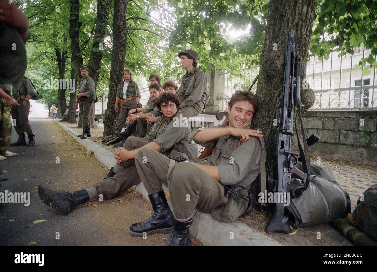 Soldiers of the Slovenian militia have a rest after the federal army of Yugoslavia withdraw from ...