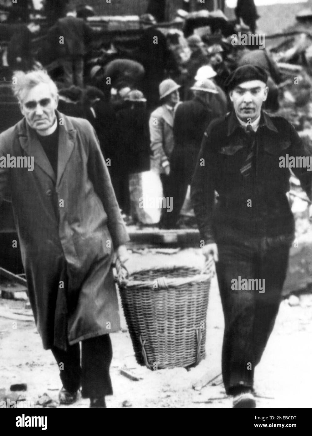 These two men are carrying debris from a wrecked building in London ...