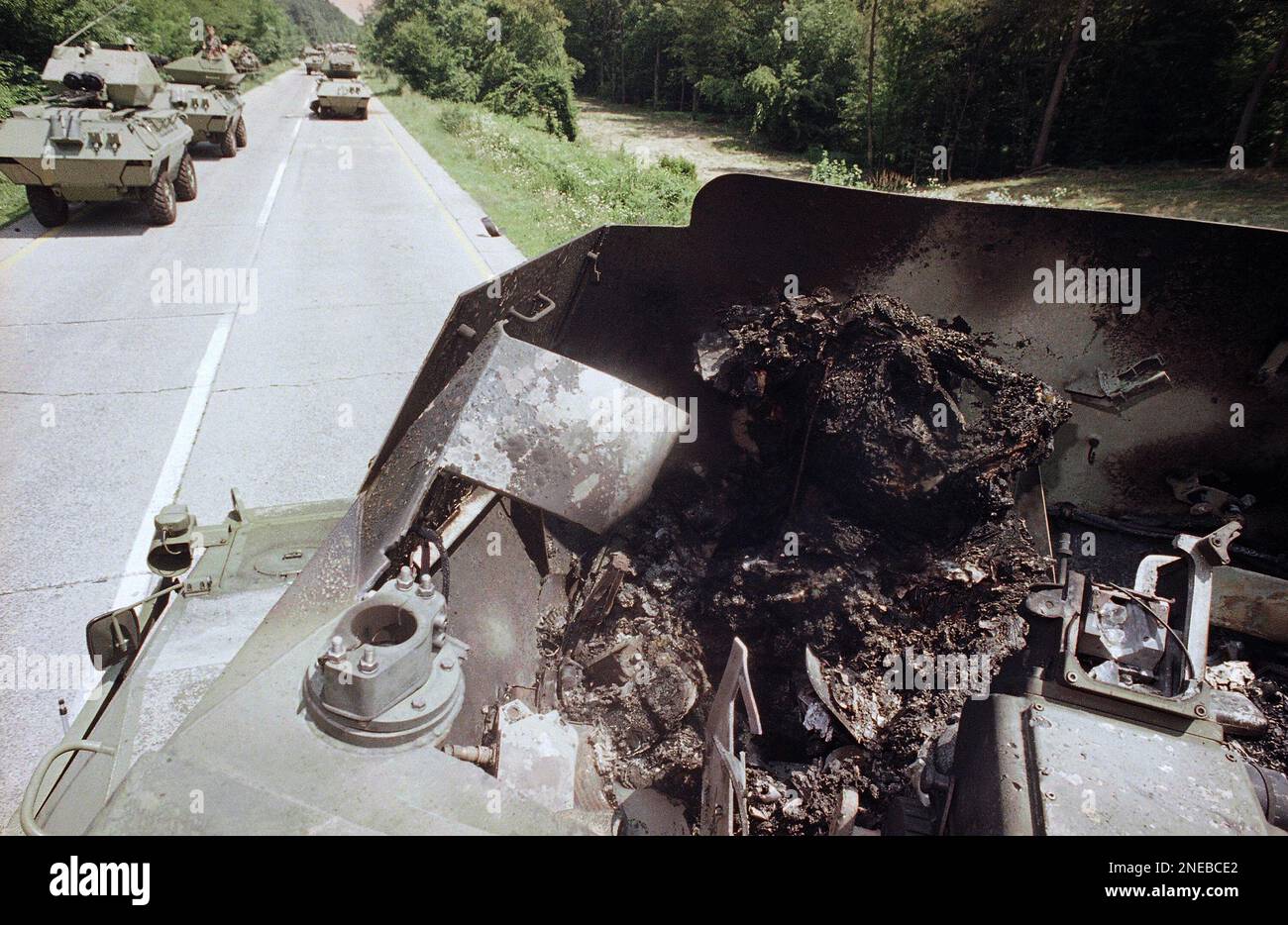 The charred remains of a Yugoslav federal army soldier sits in the ...