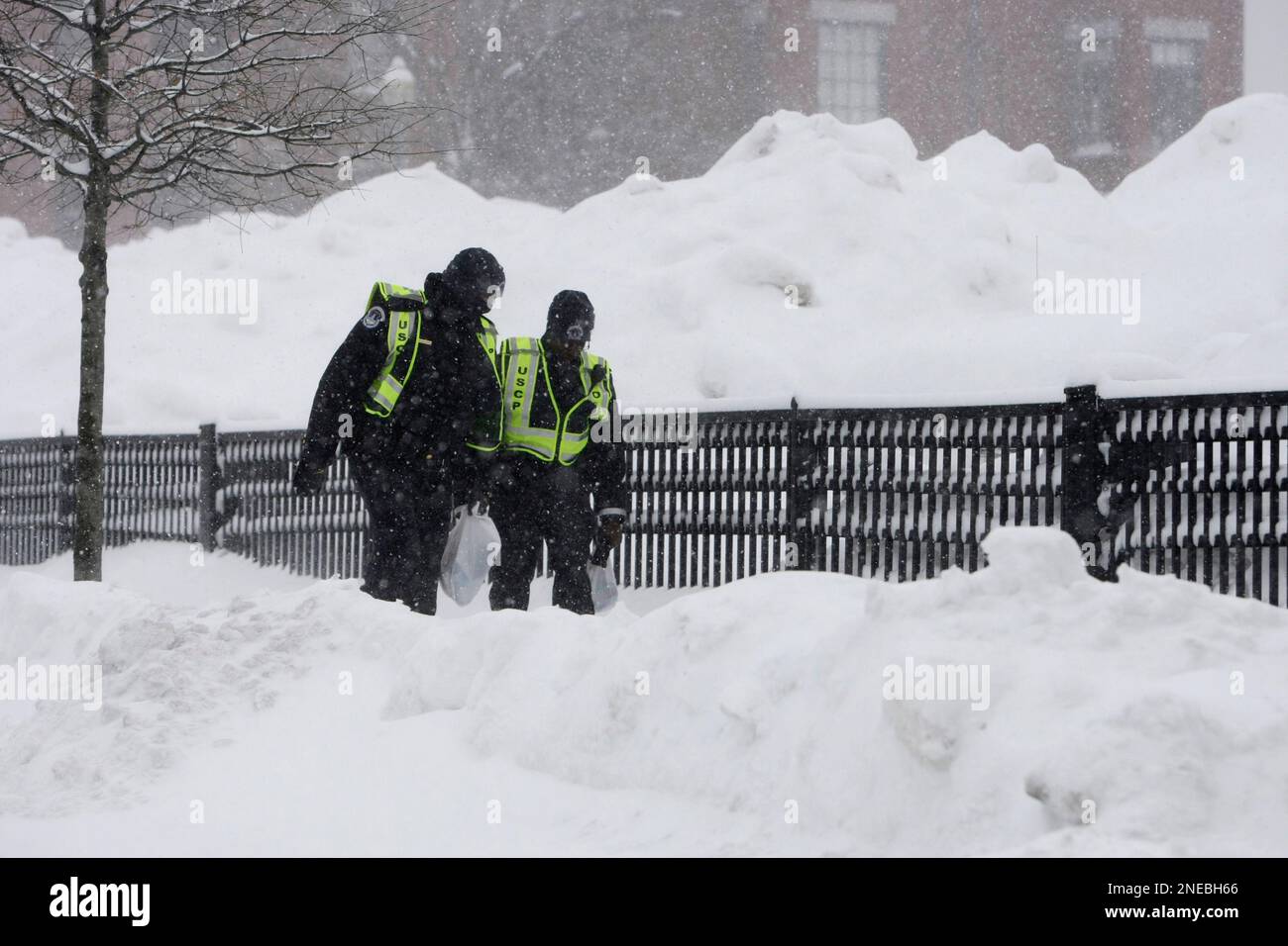 Two U.S. Capitol Police officers walk through an intense winter ...