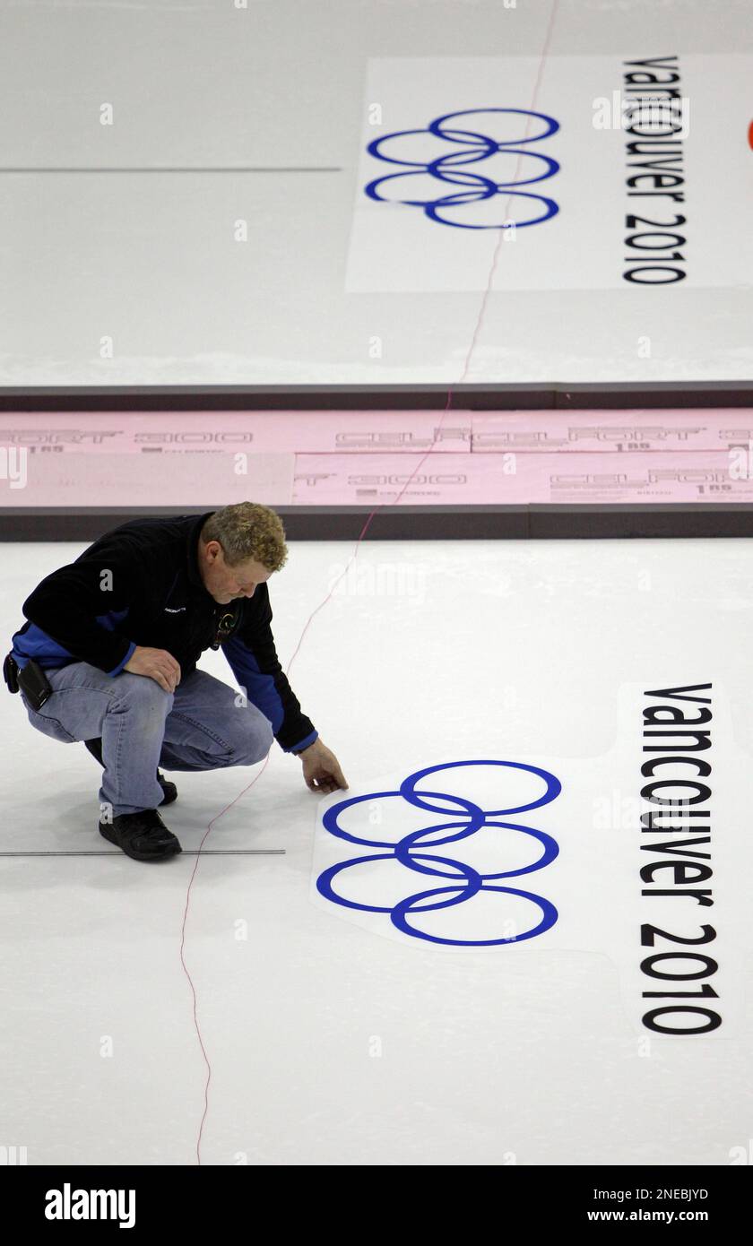 Hans Wuthrich, chief ice-maker from Gimley, Manitoba, places the ...