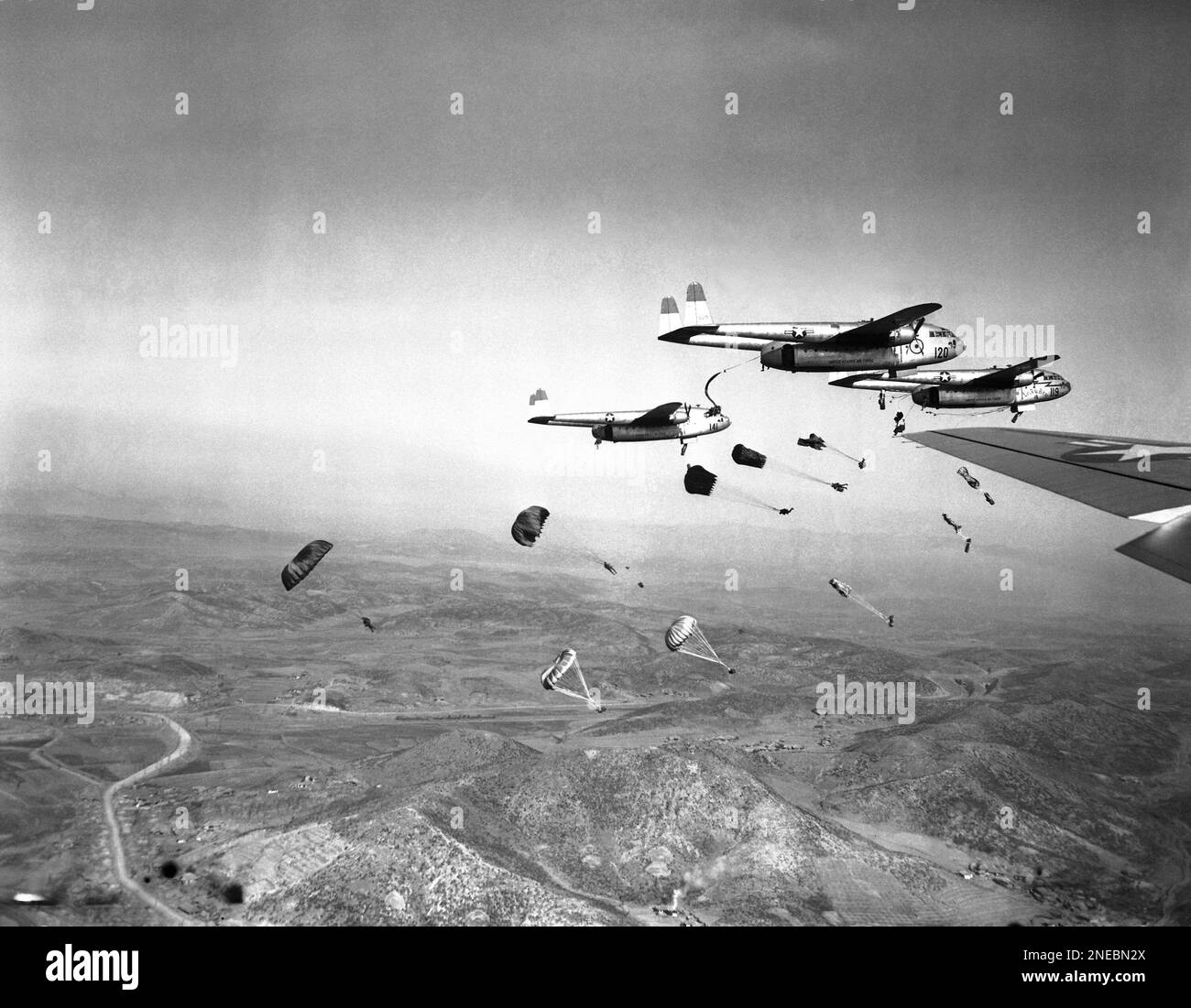 Vari-colored parachutes blossom out as the men of the 187th Airborne ...