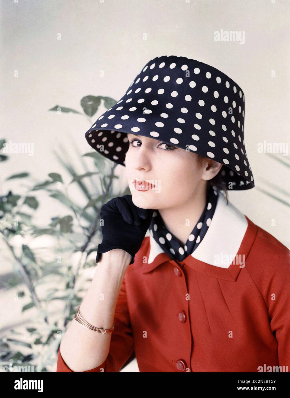 A fashion model wears an Italian hat with white polka dots, red dress ...