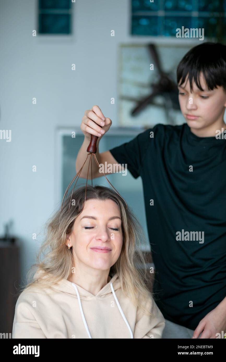 Portrait of happy blond middle-aged woman sitting with closed eyes ...