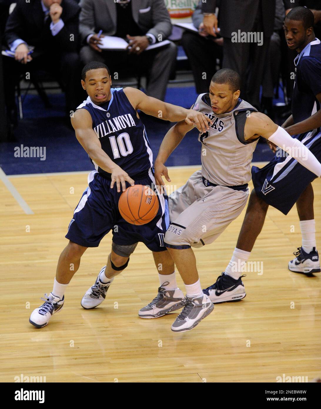 Villanova's Corey Fisher (10) tries to dribble around Georgetown's ...