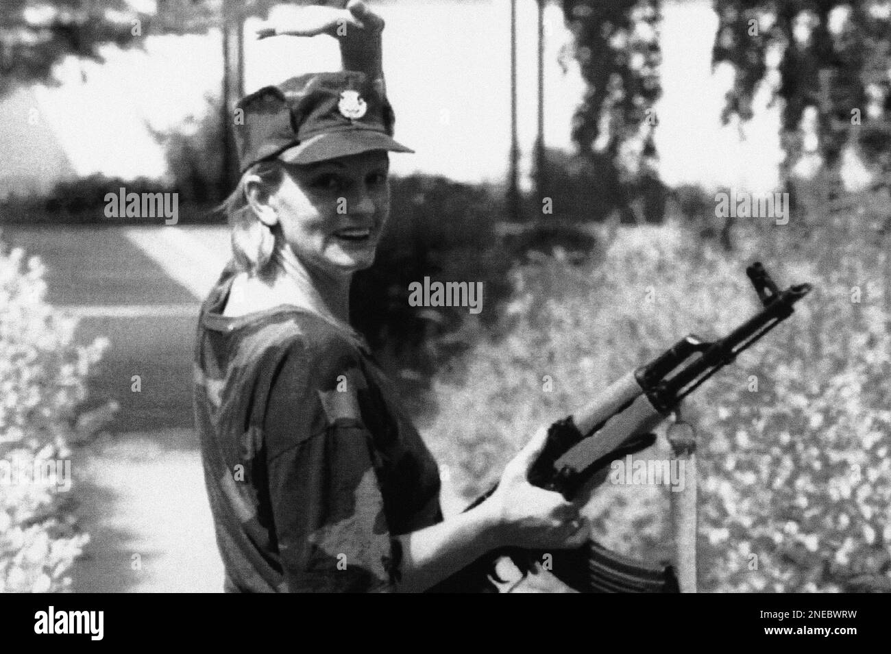 A young woman equipped with gun and uniform of the Croatian National ...