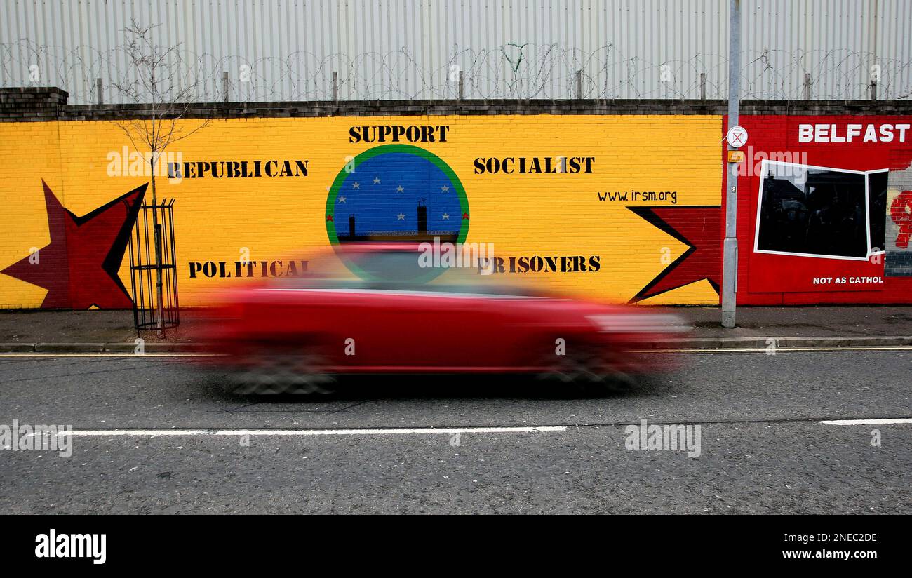 A car passes a mural from the Irish National Liberation Army, (INLA ...