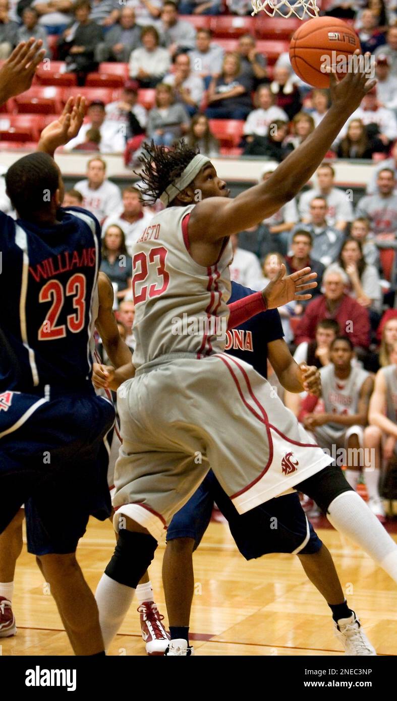 Washington State forward DeAngelo Casto, center, grabs a rebound as ...